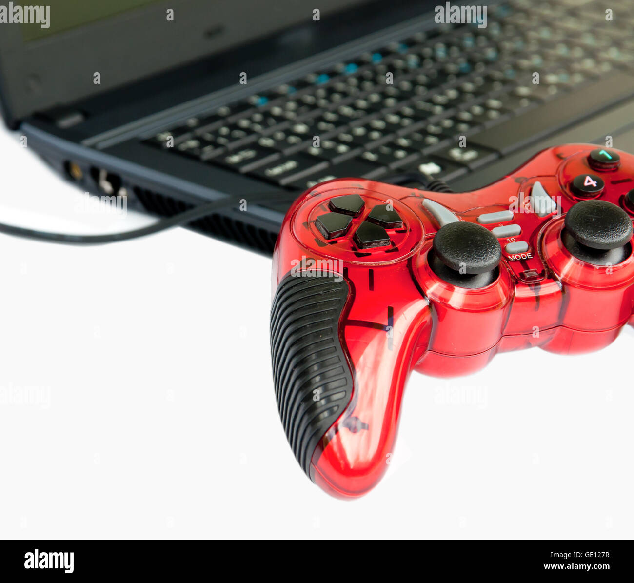 red joystick game controller on laptop isolated on white background ...