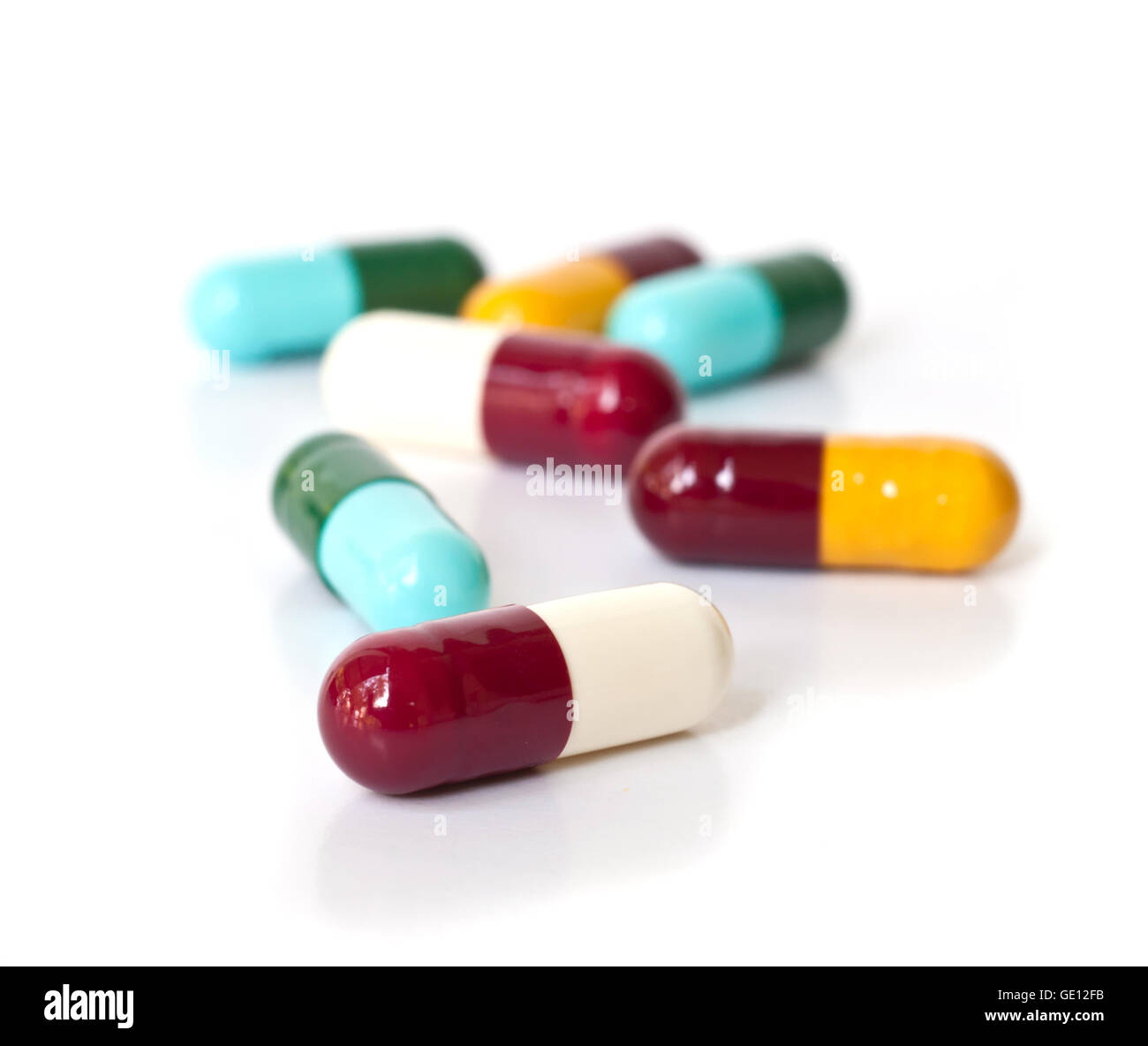 Colorful medical capsules on white background Stock Photo - Alamy