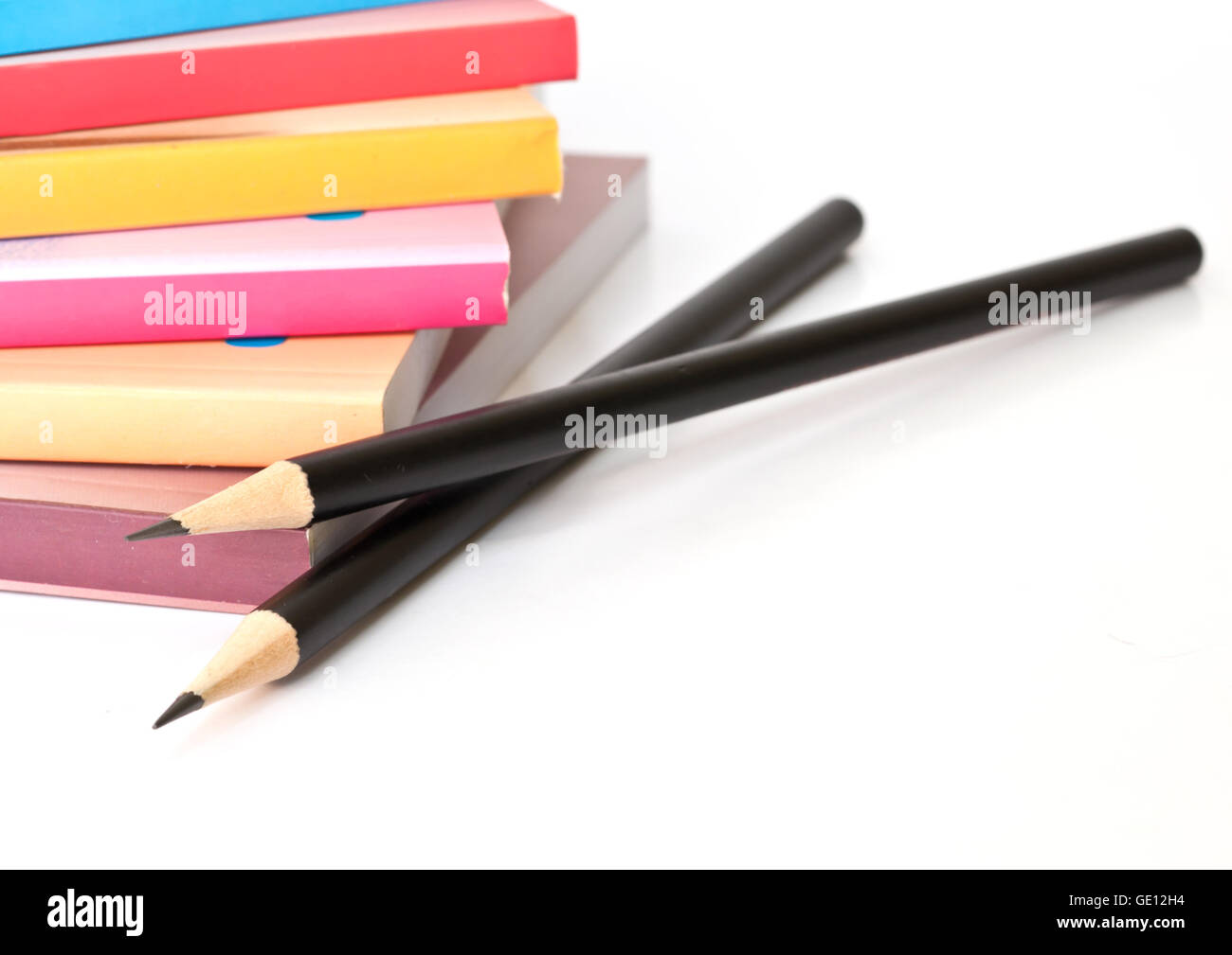 Colour Books with pencil isolated on white background Stock Photo - Alamy