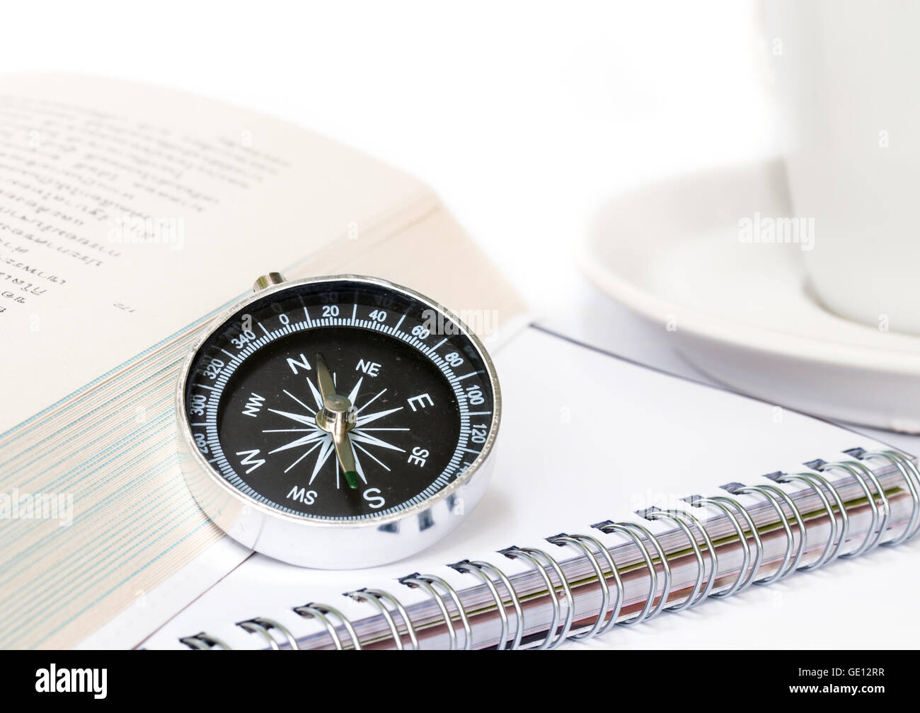 Compass with the book on white background Stock Photo - Alamy