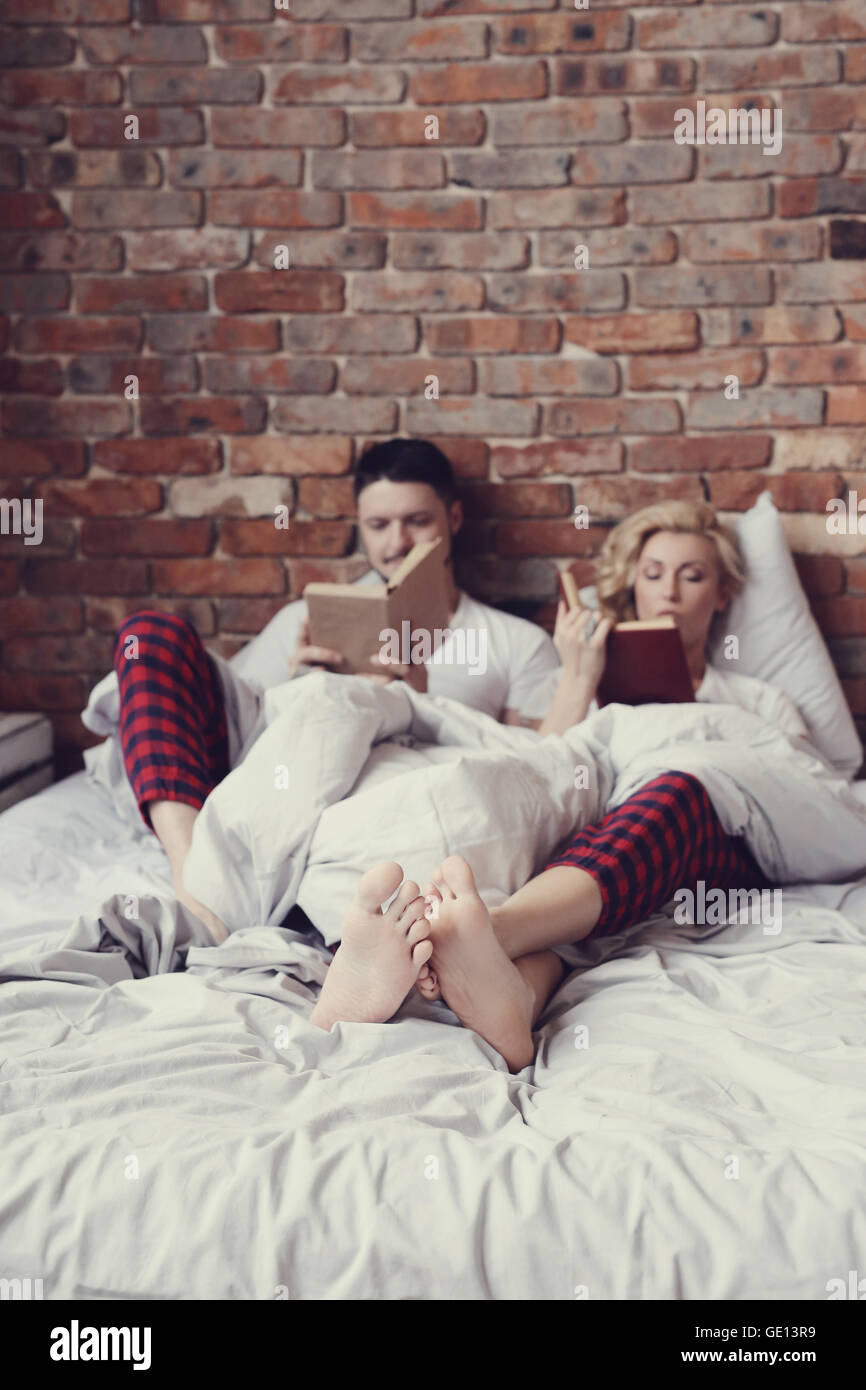 Couple reading in bed wall hi-res stock photography and images - Alamy