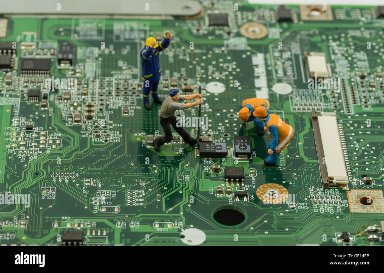 mini worker and technician work on mainboard as a teamwork - can use to ...