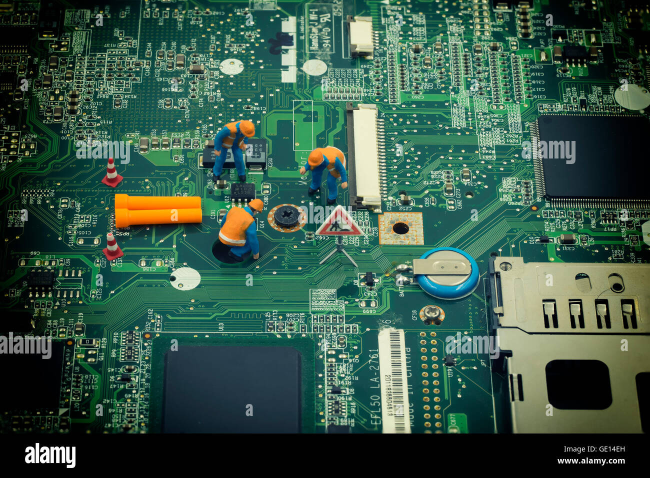 group of mini technician find out to remove a screw on mainboard and ...
