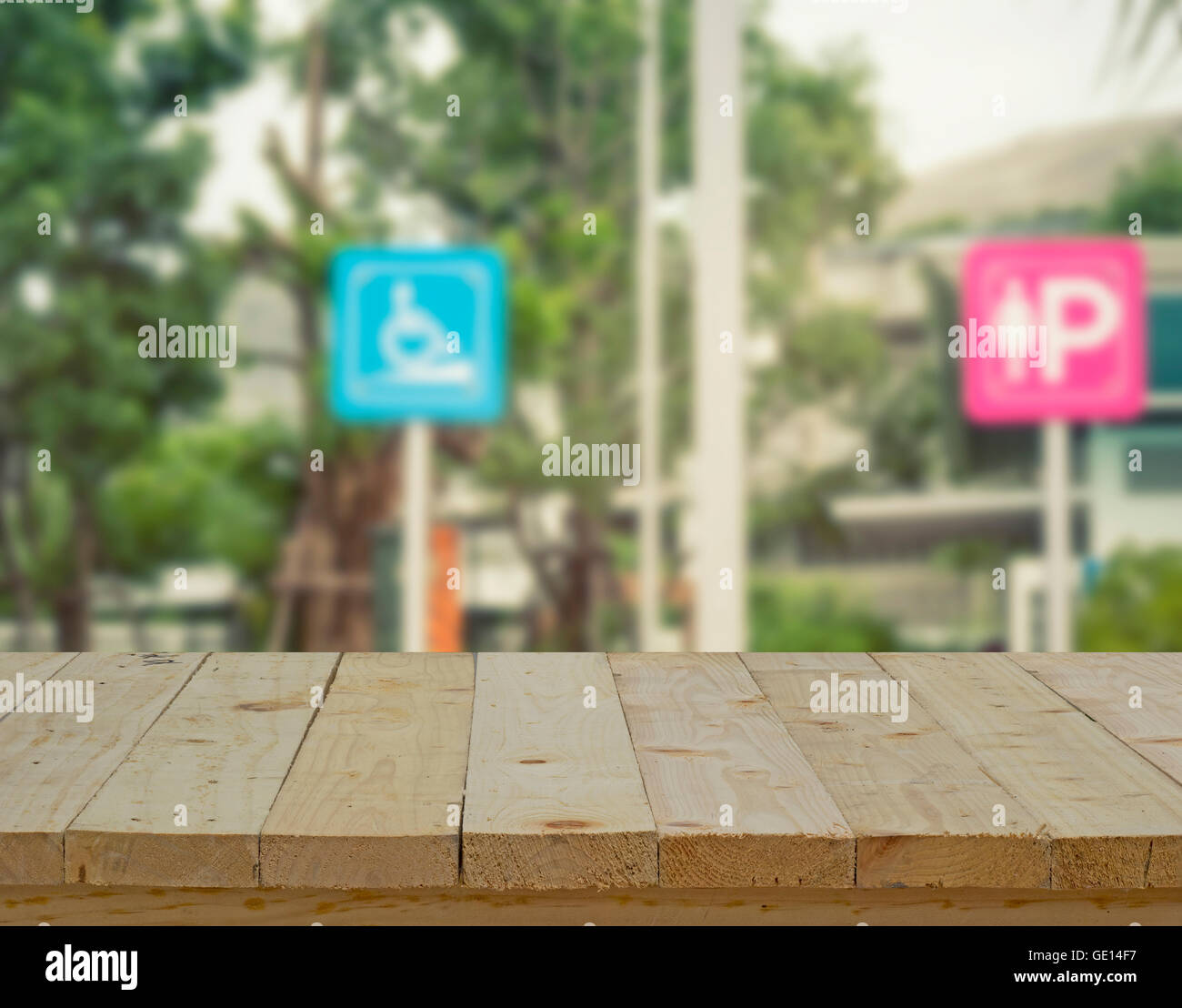 wood table top on blur of sign in gas station - can use to display or ...