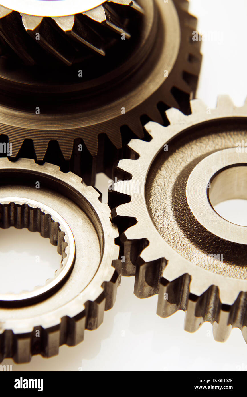 Metal cog gears joining together Stock Photo - Alamy