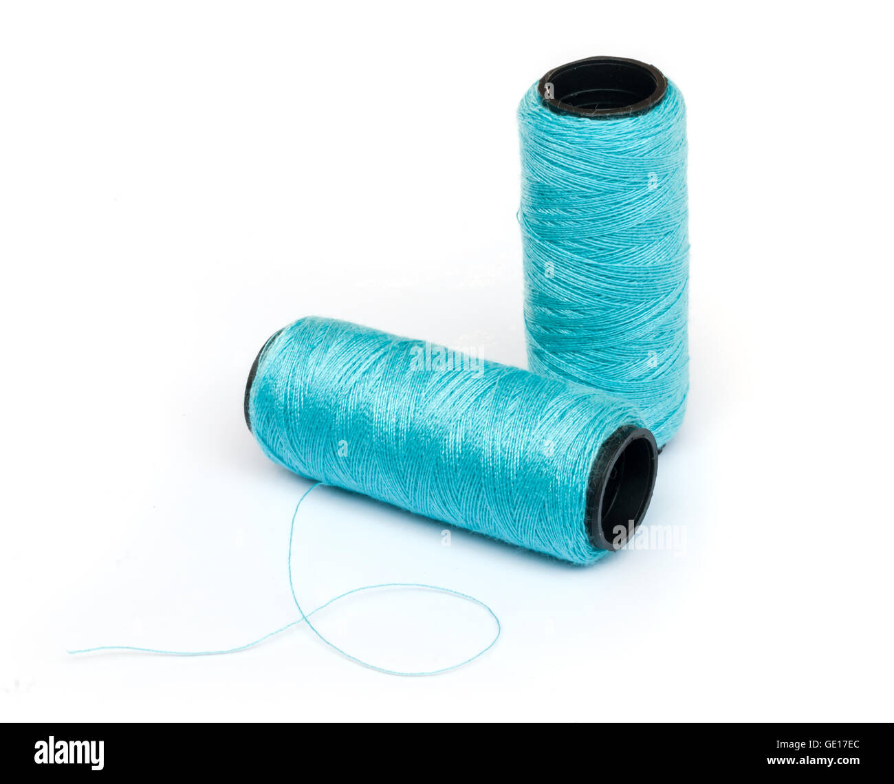 Spool of blue thread on white background Stock Photo - Alamy
