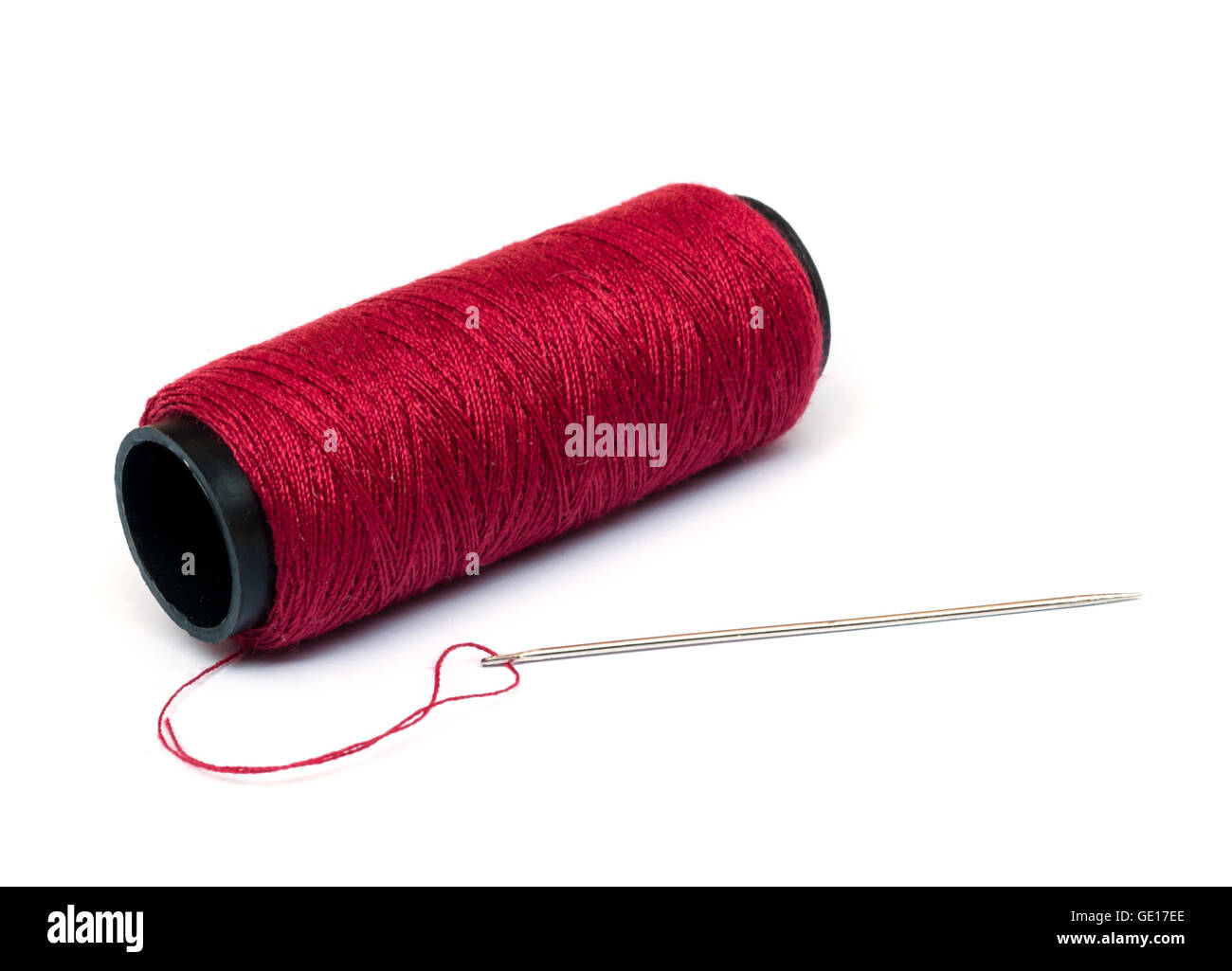 Spool of red thread and needle isolated on white background Stock Photo ...