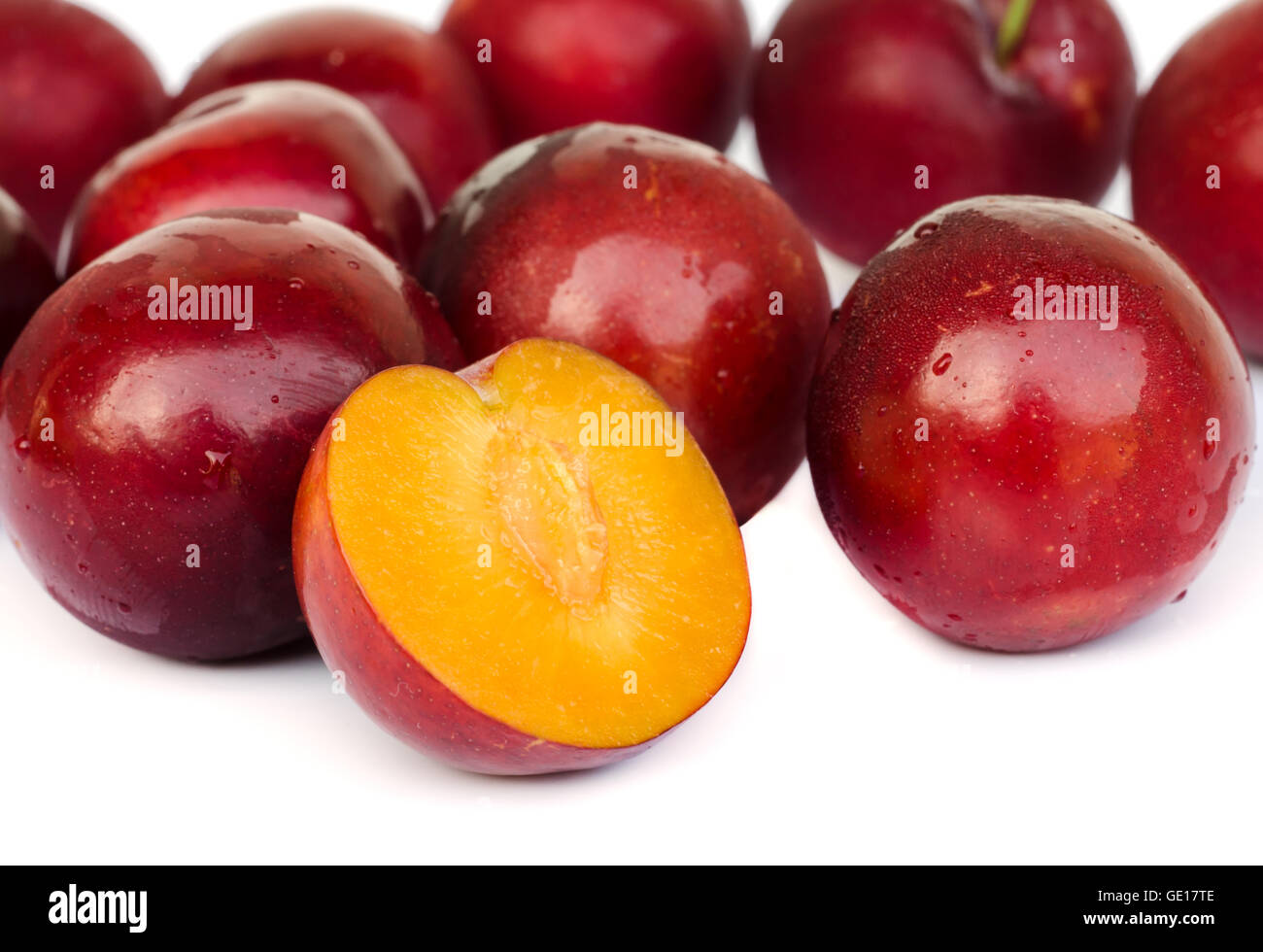 Ripe plums isolated on white background Stock Photo - Alamy