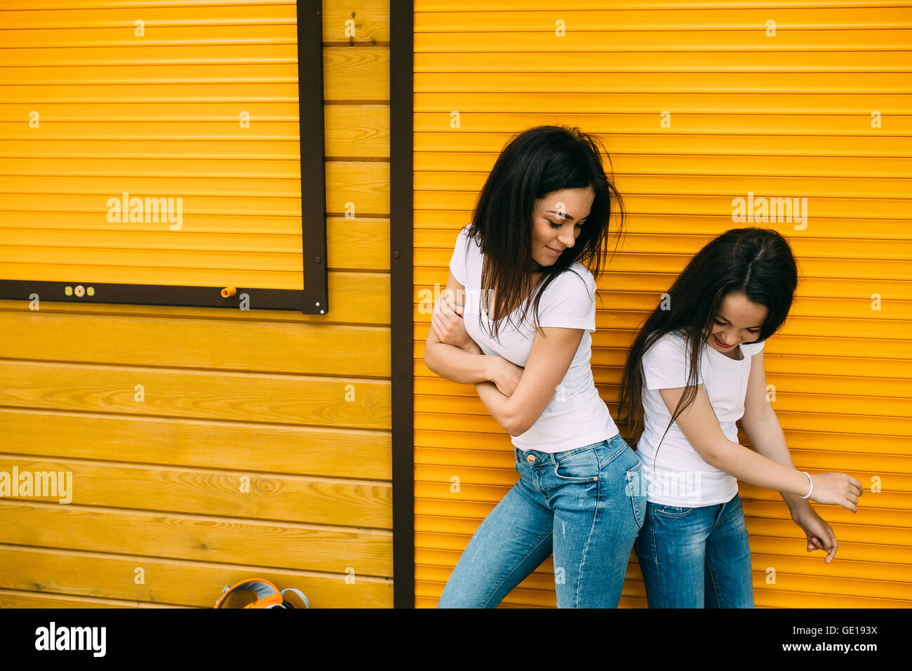 mother and her cute daughter, against wall Stock Photo - Alamy