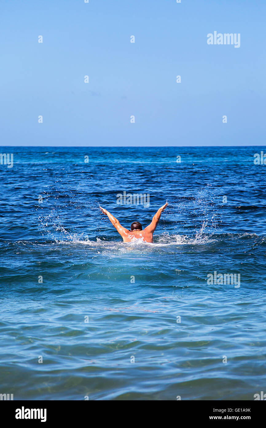 A muscular man swims in the water of sea Stock Photo - Alamy