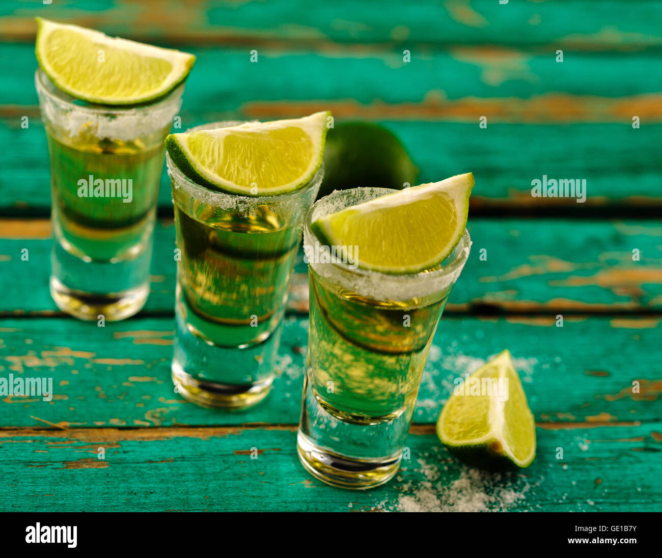 Mexican Gold Tequila with lime and salt on wooden table, selective ...