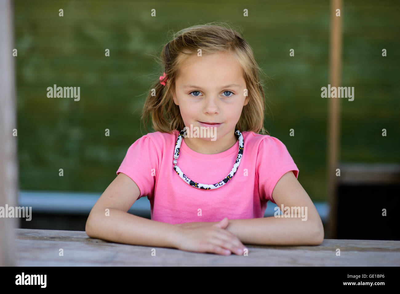 Portrait girl sitting table hi-res stock photography and images - Alamy