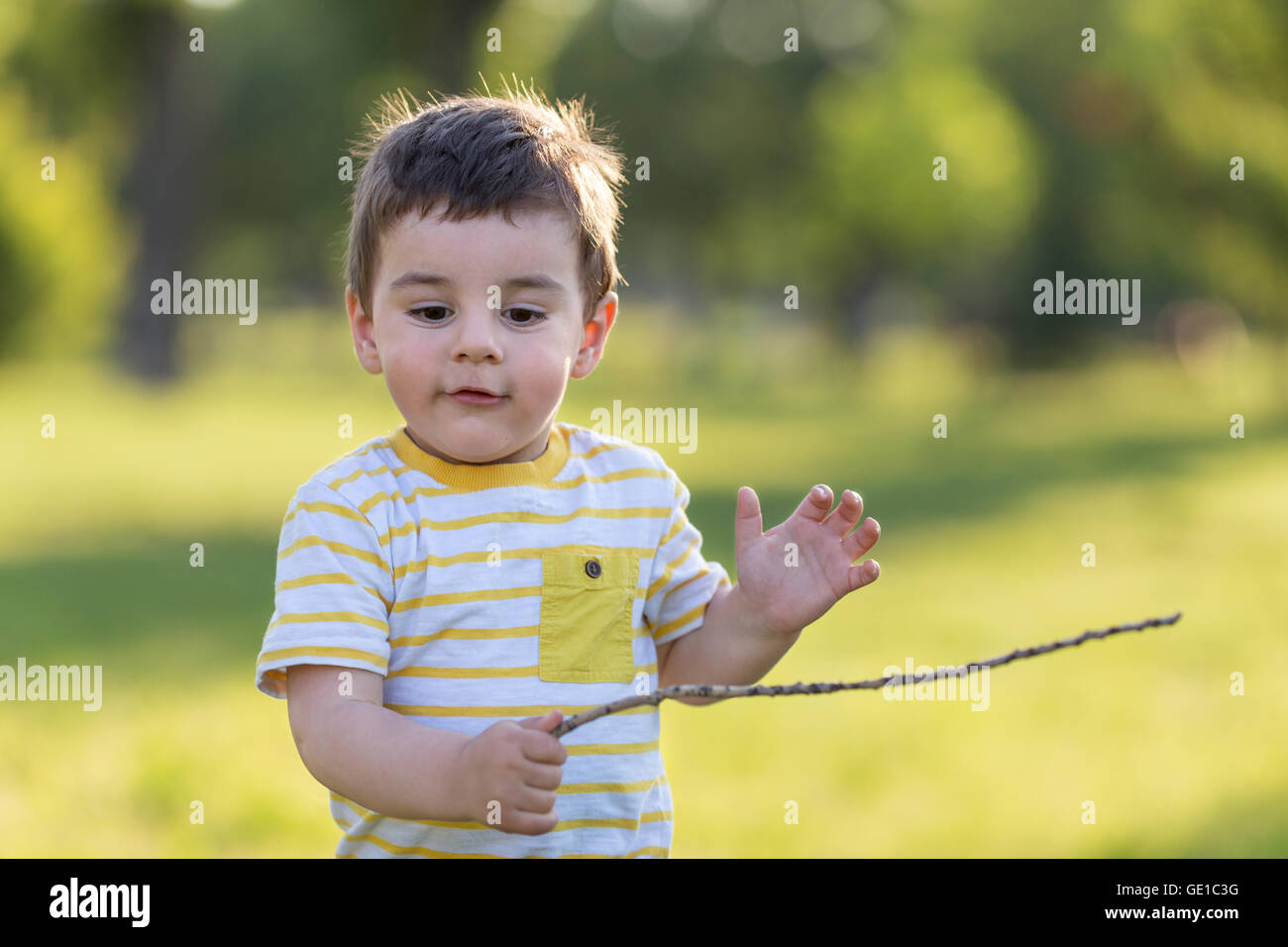 Boy holding stick running Stock Photo - Alamy