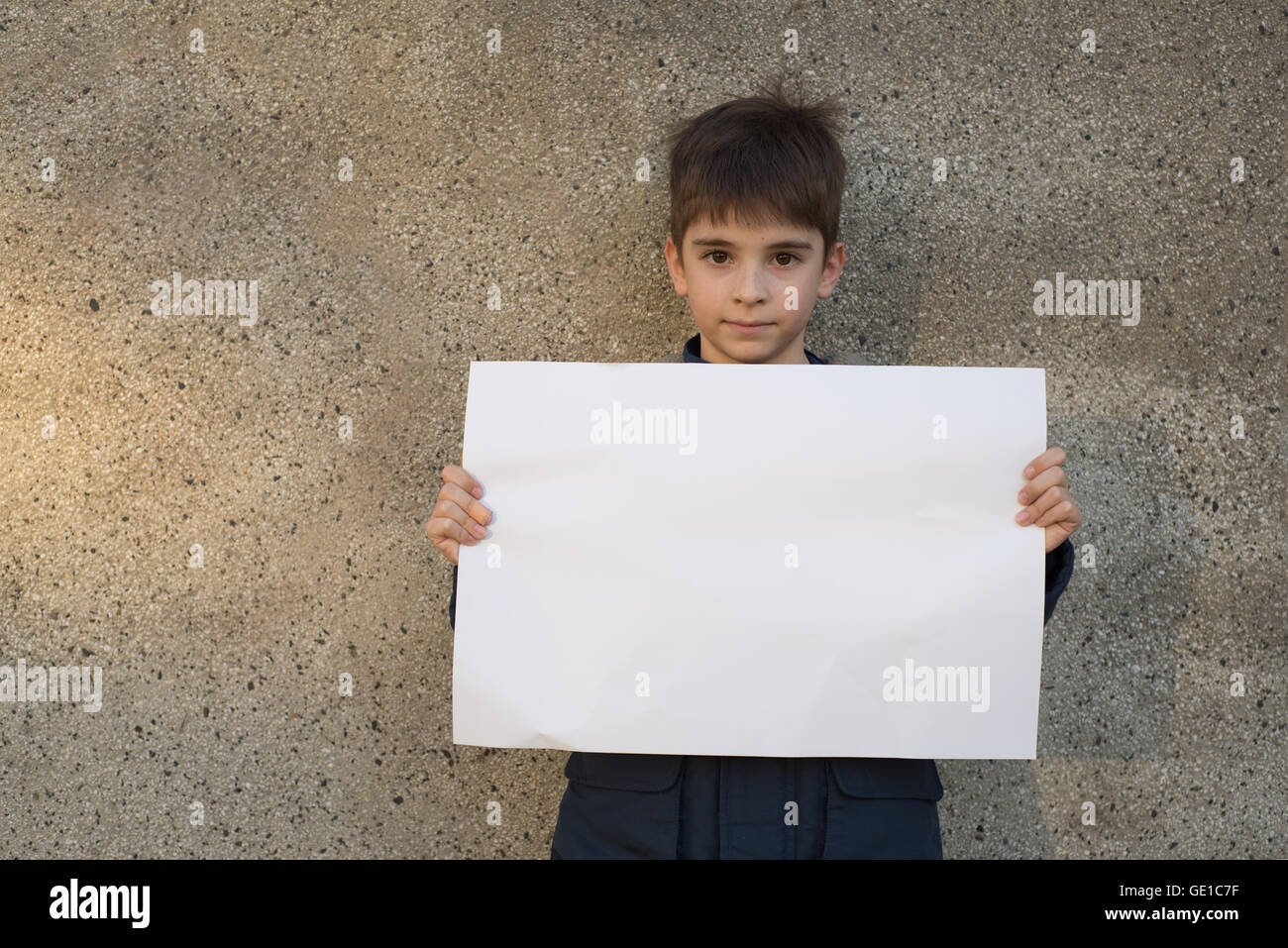 A boy holding a piece of blank paper Stock Photo - Alamy