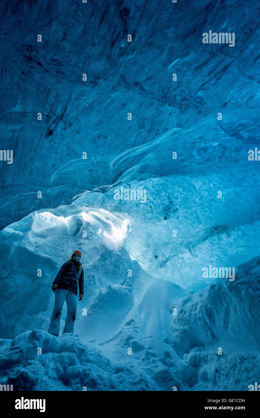 Woman walking through frozen ice cave, Vatna Glacier, Iceland Stock ...