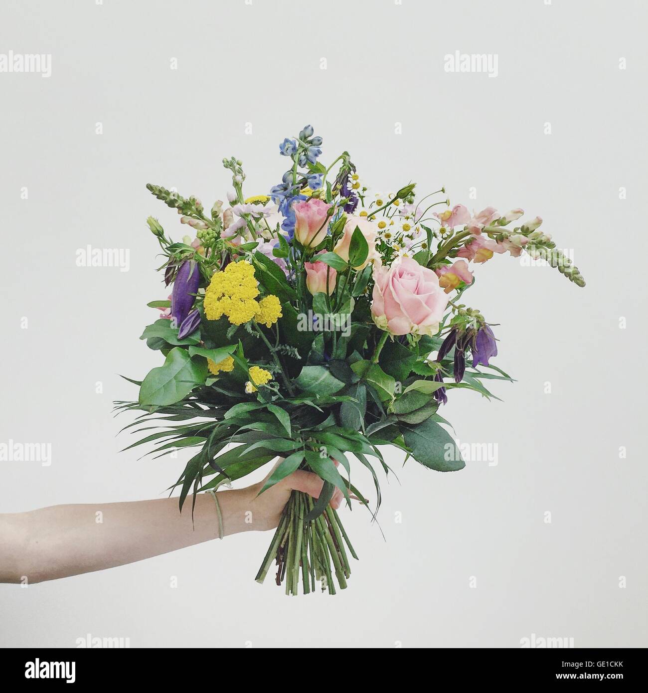 Hand holding bouquet of flowers Stock Photo - Alamy