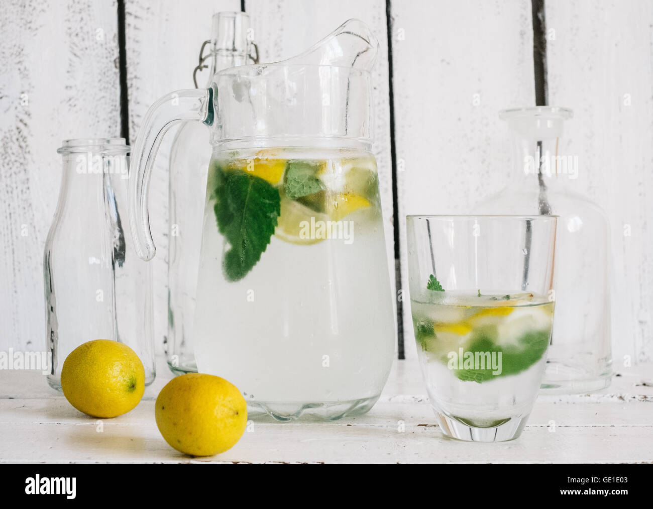 Glass pitcher with fresh lemon, lime, mint and ice-cubes Stock Photo ...