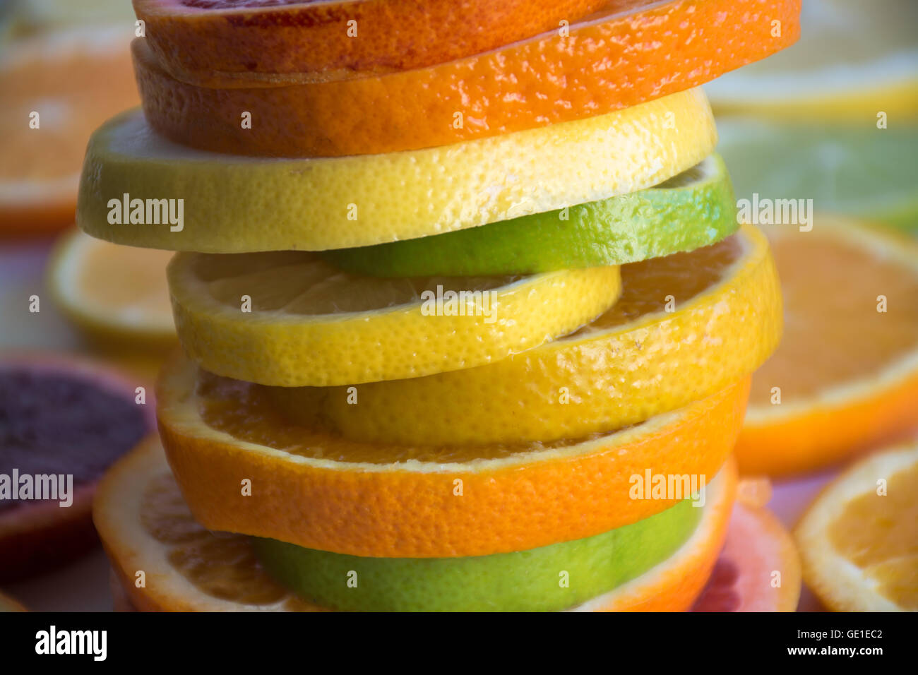 Slices of various citrus types arranged in a colorful stack Stock Photo ...