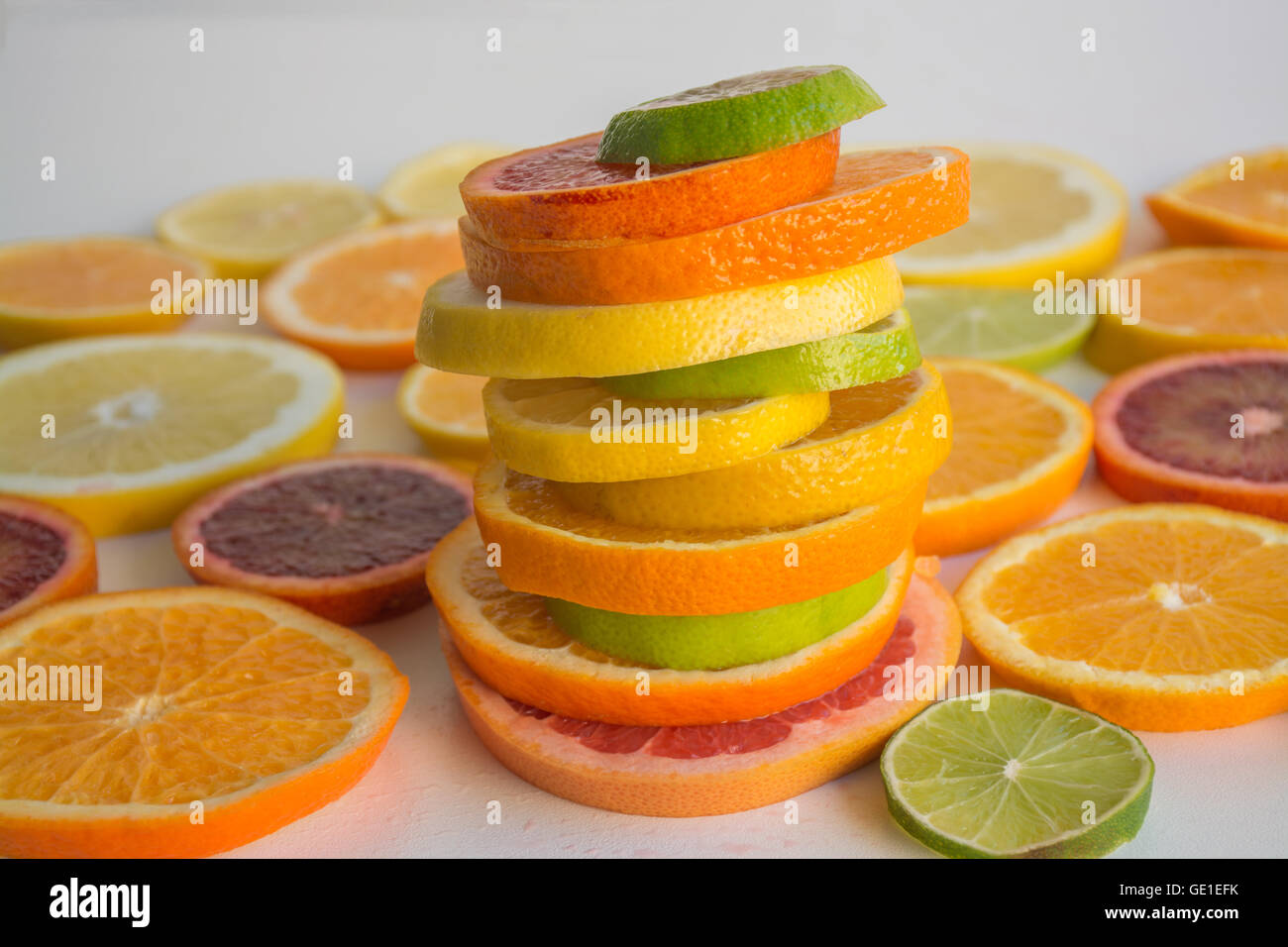 Slices of various citrus types arranged in a colorful stack Stock Photo ...