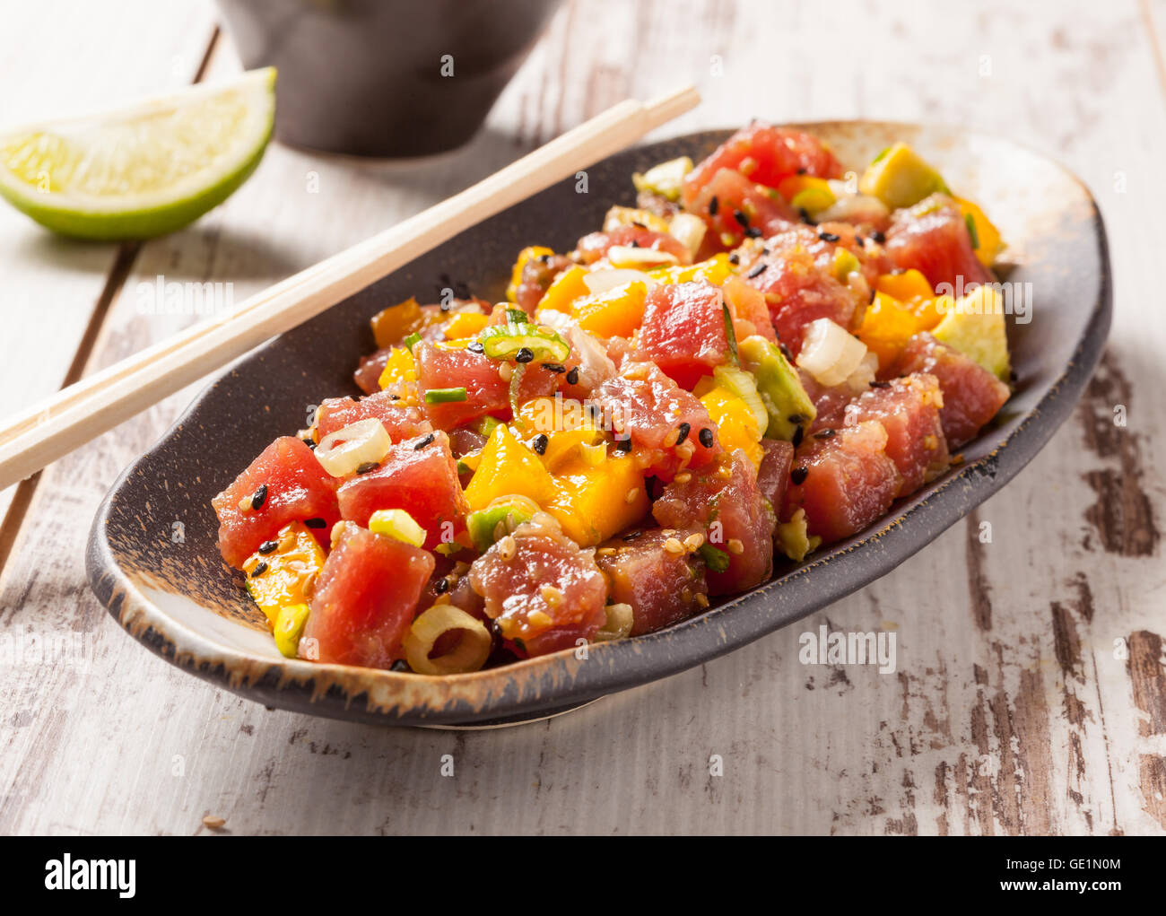 Hawaiian tuna poke with mango, avocado, onion and sesame seeds Stock ...
