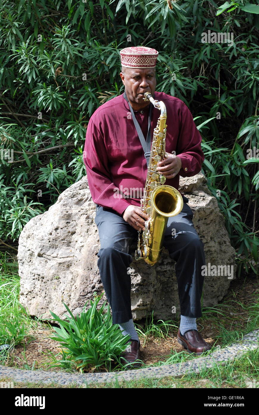 Jazz musician blowing his saxophone outside Stock Photo - Alamy