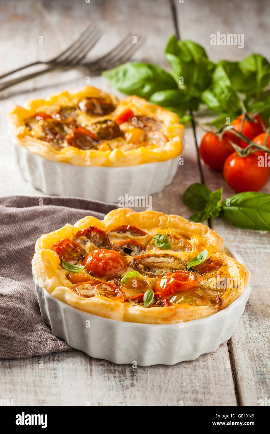 Quiche with cherry tomatoes on a rustic wooden table Stock Photo - Alamy