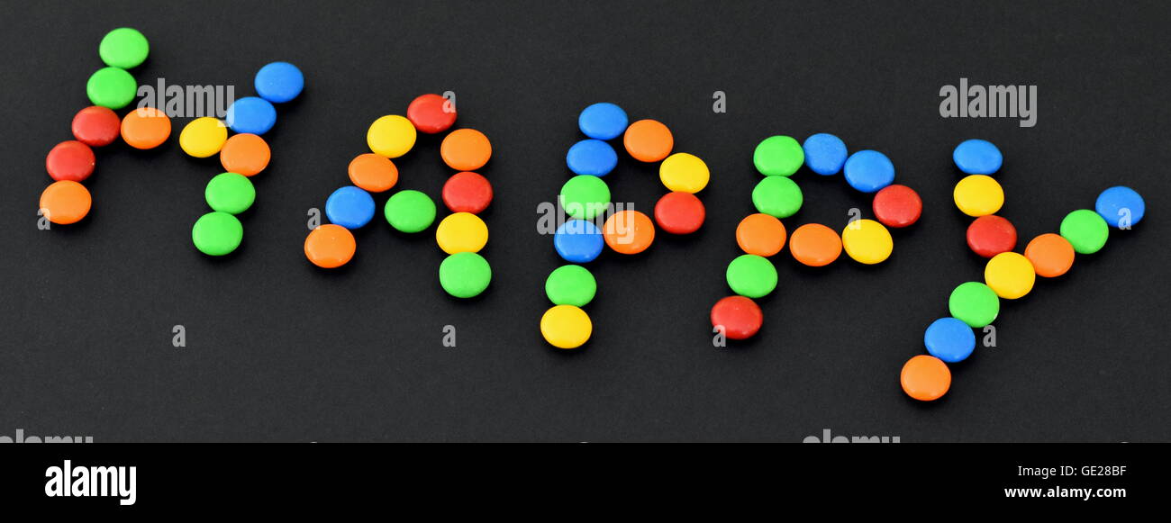 Closeup of the pile of colorful sweet bonbons with "HAPPY" title Stock ...