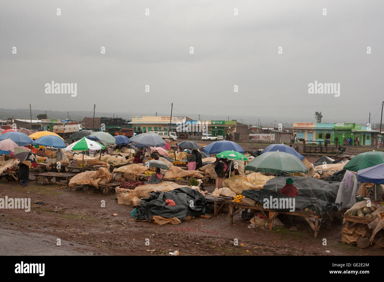 A typical market place scene with vegetable vendors hair salons laundry ...