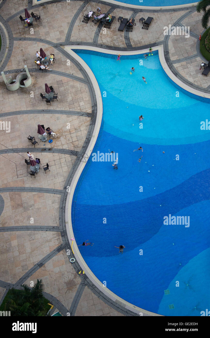 Swimming pool in your society complex with people chilling out housing ...
