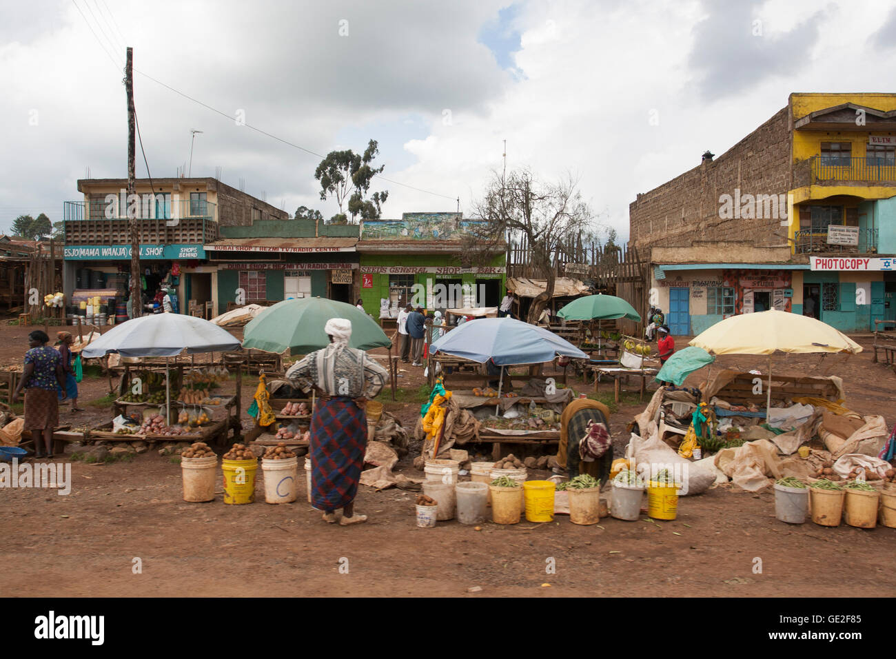 A typical market place scene with vegetable vendors hair salons laundry ...