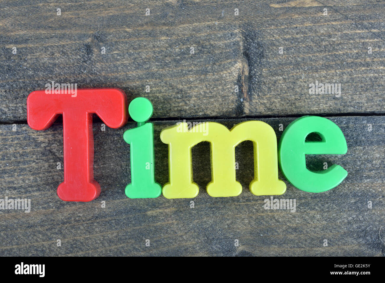 Time word on wooden table Stock Photo - Alamy