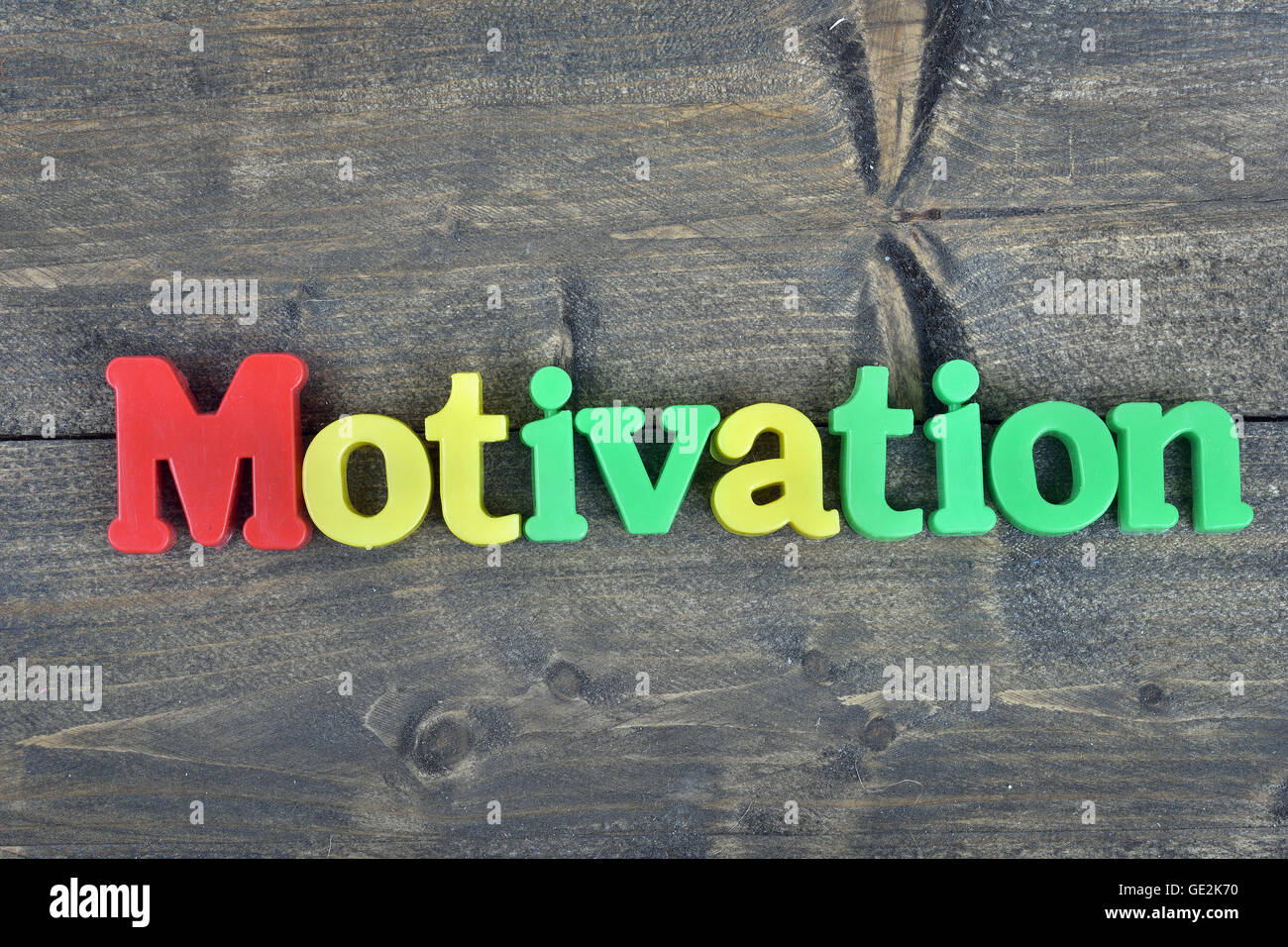 Motivation word on wooden table Stock Photo - Alamy