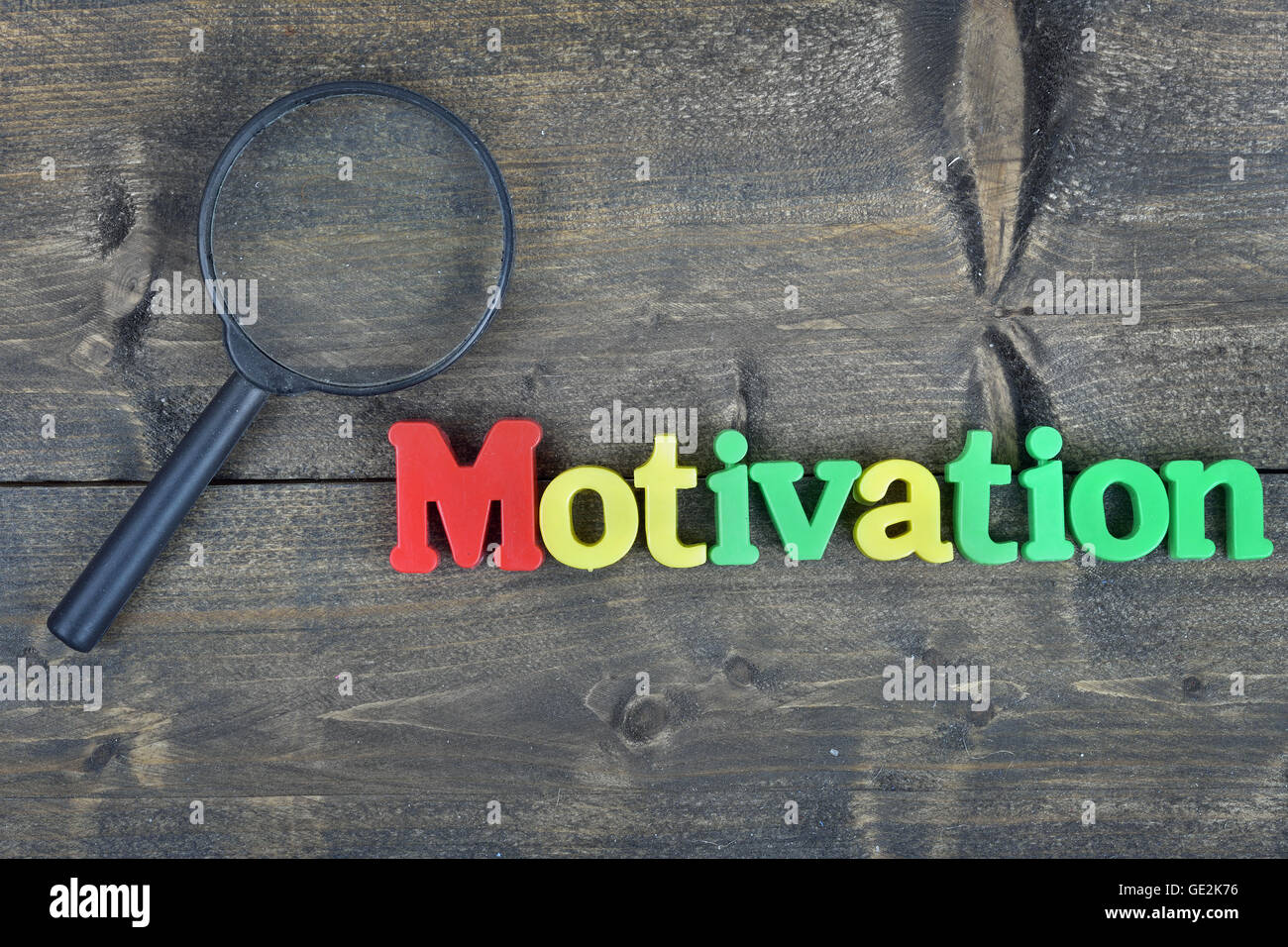 Motivation word on wooden table Stock Photo - Alamy