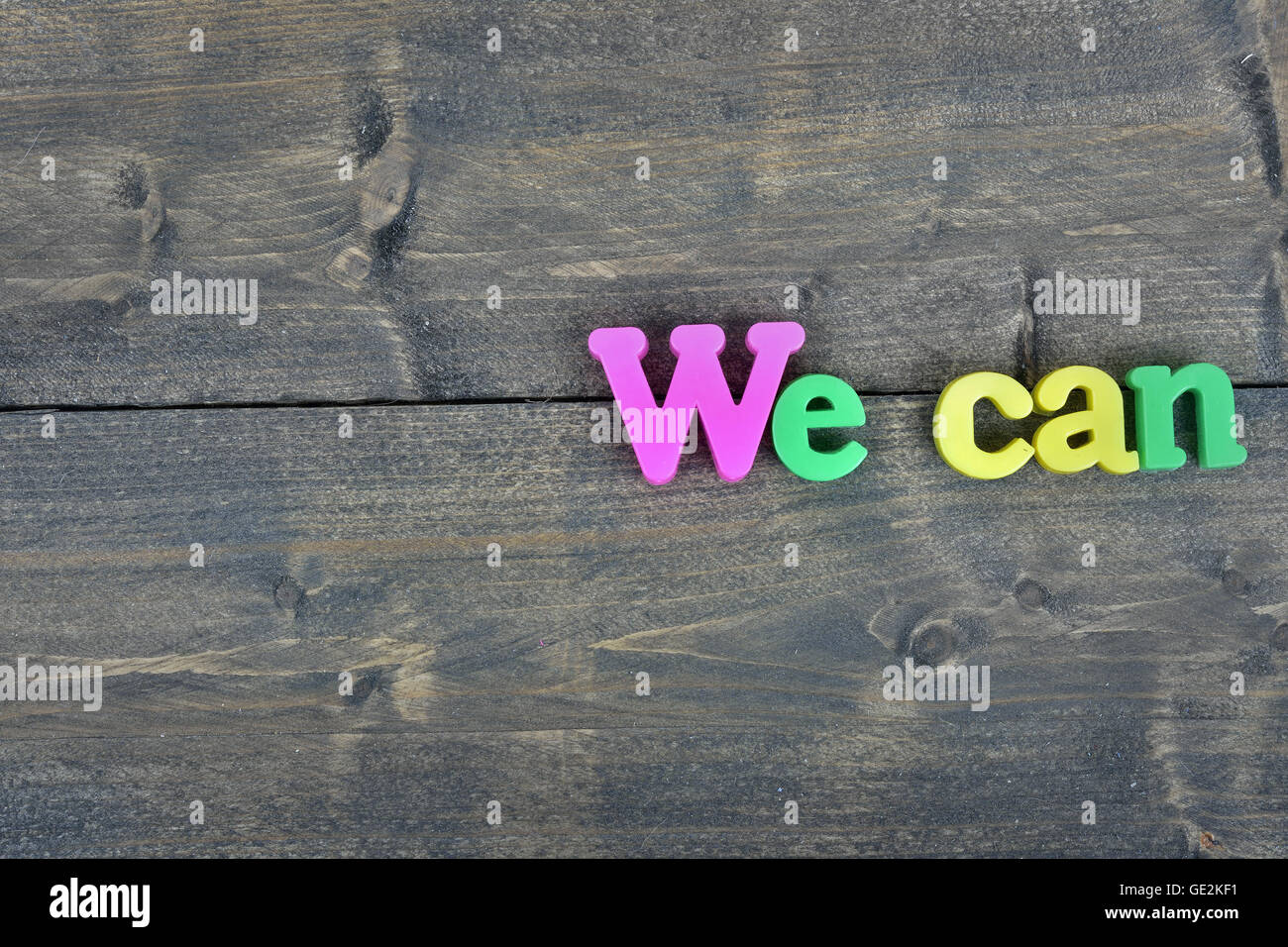 We Can word on wooden table Stock Photo - Alamy