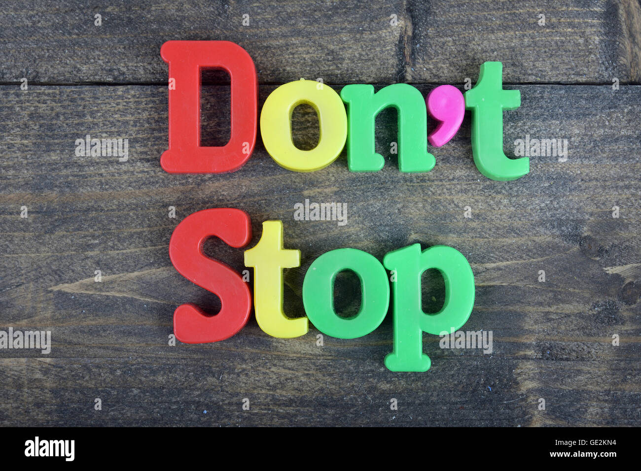 Don't stop word on wooden table Stock Photo - Alamy