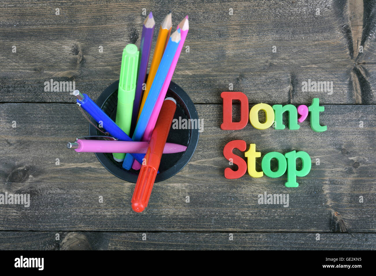 Don't stop word on wooden table Stock Photo - Alamy