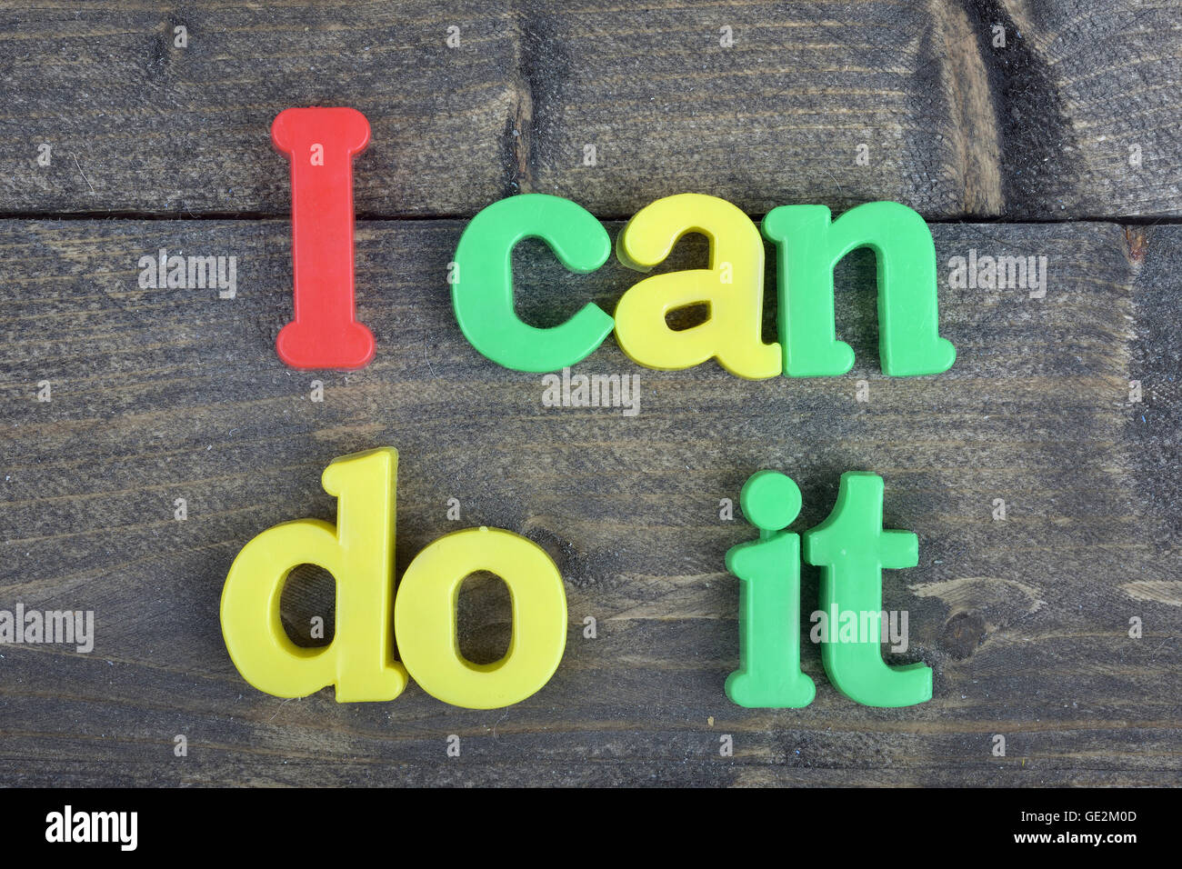 I can do it word on wooden table Stock Photo - Alamy