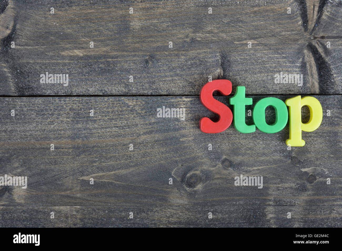 Stop word on wooden table Stock Photo - Alamy