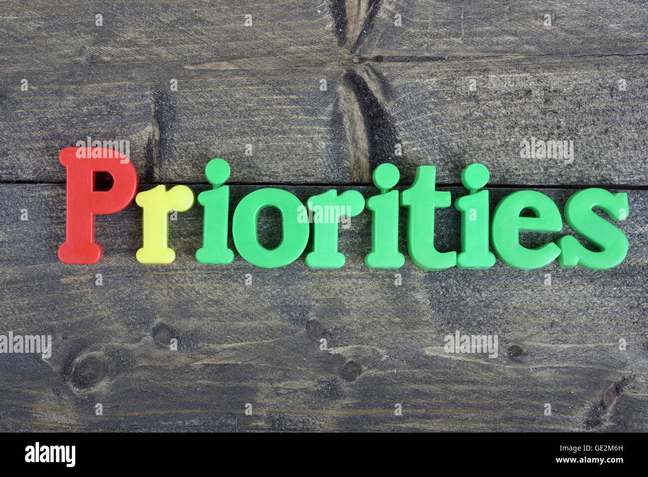 Priorities word on wooden table Stock Photo - Alamy