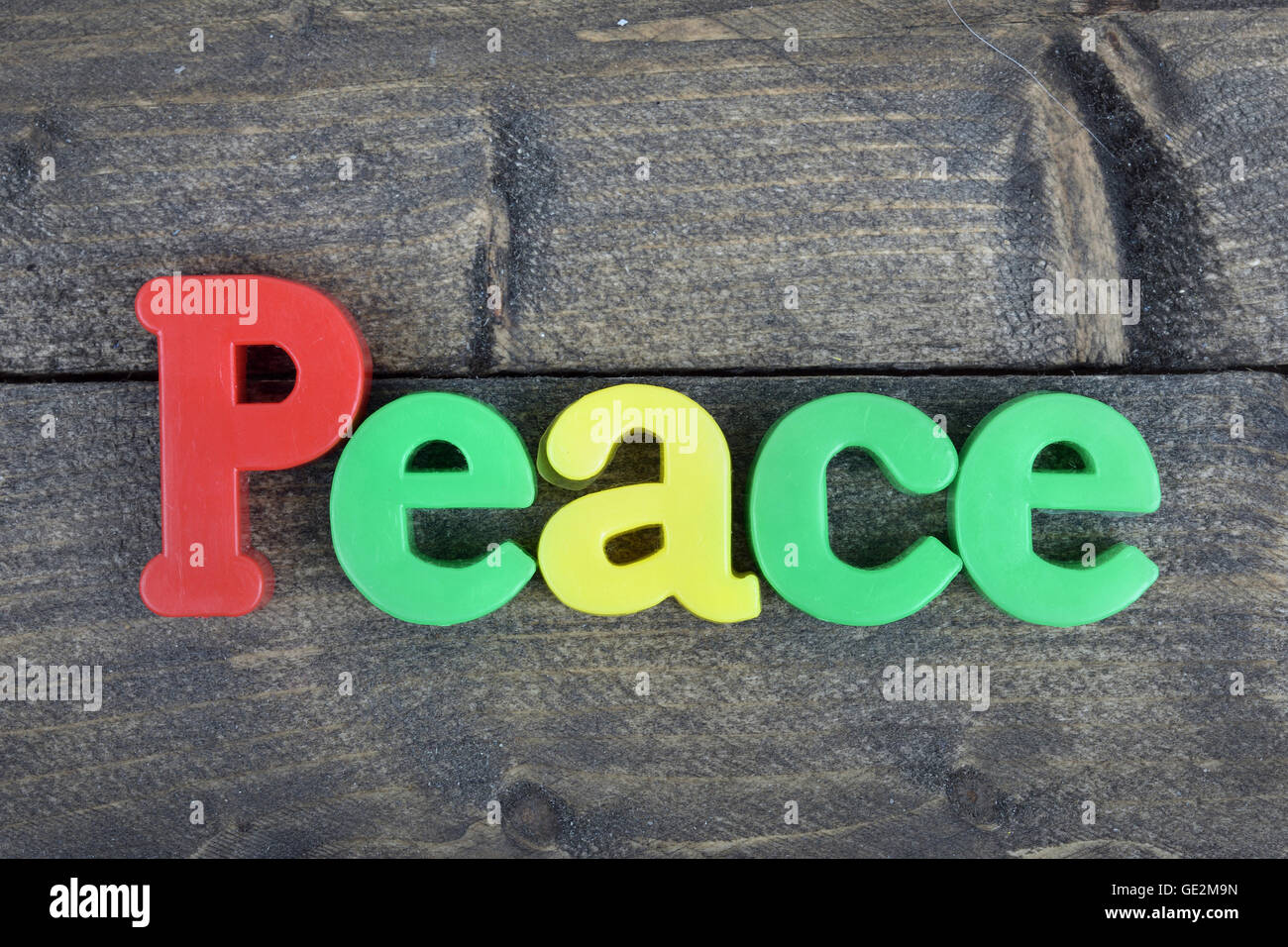 Peace word on wooden table Stock Photo - Alamy
