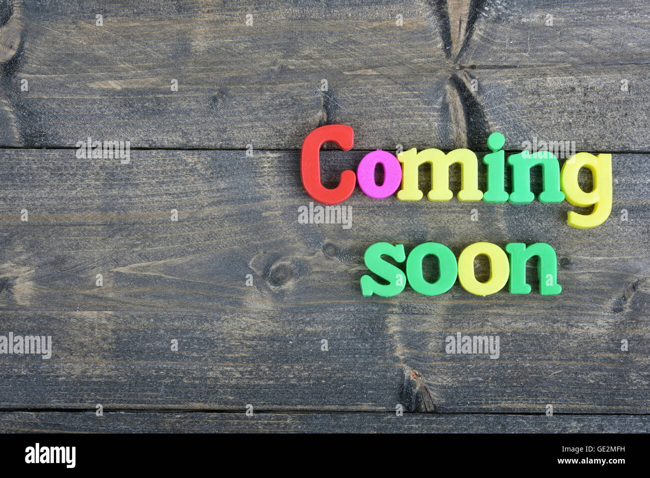 Coming Soon word on wooden table Stock Photo - Alamy