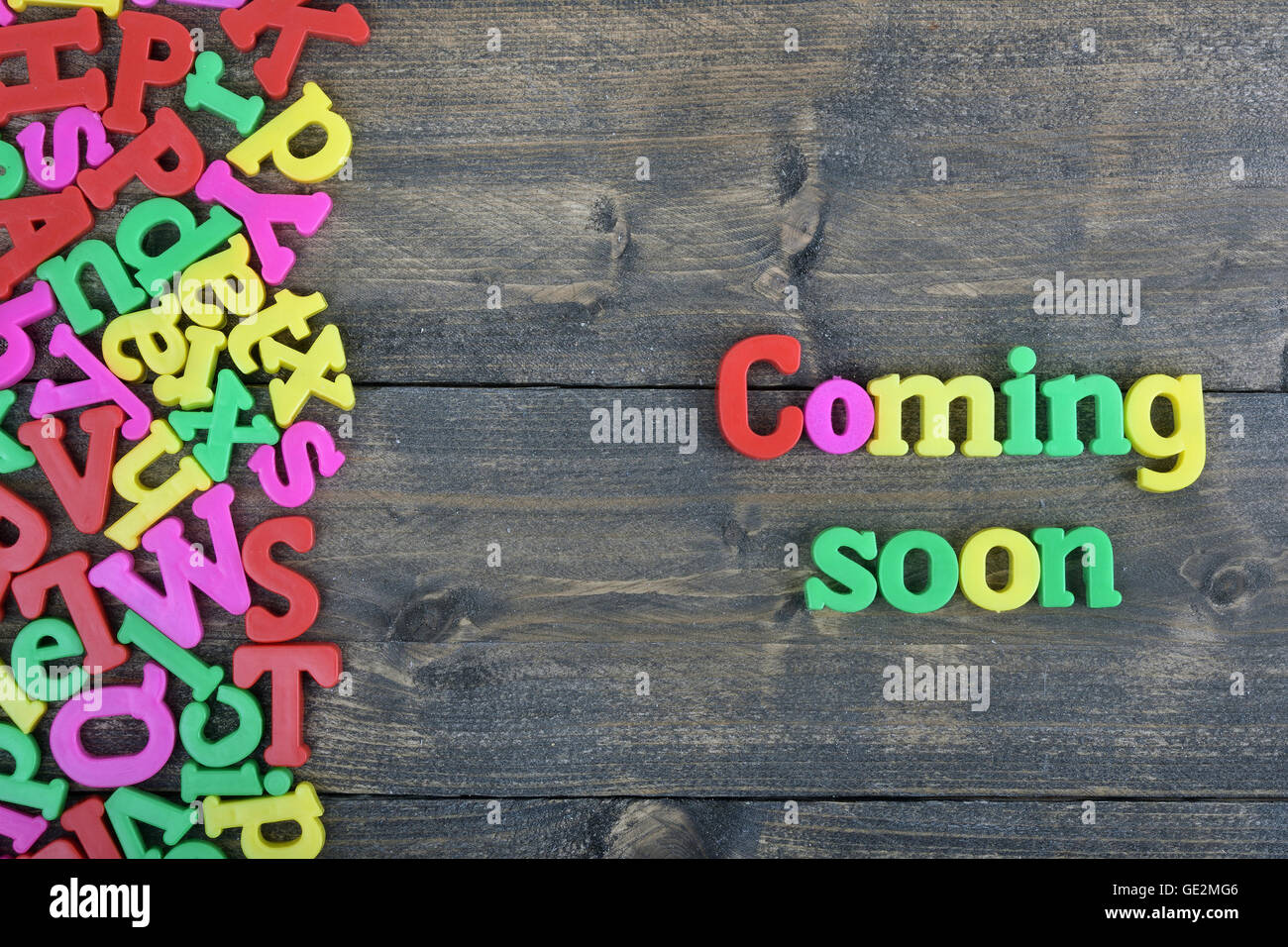 Coming Soon word on wooden table Stock Photo - Alamy
