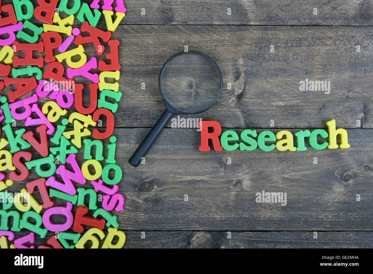 Research word on wooden table Stock Photo - Alamy