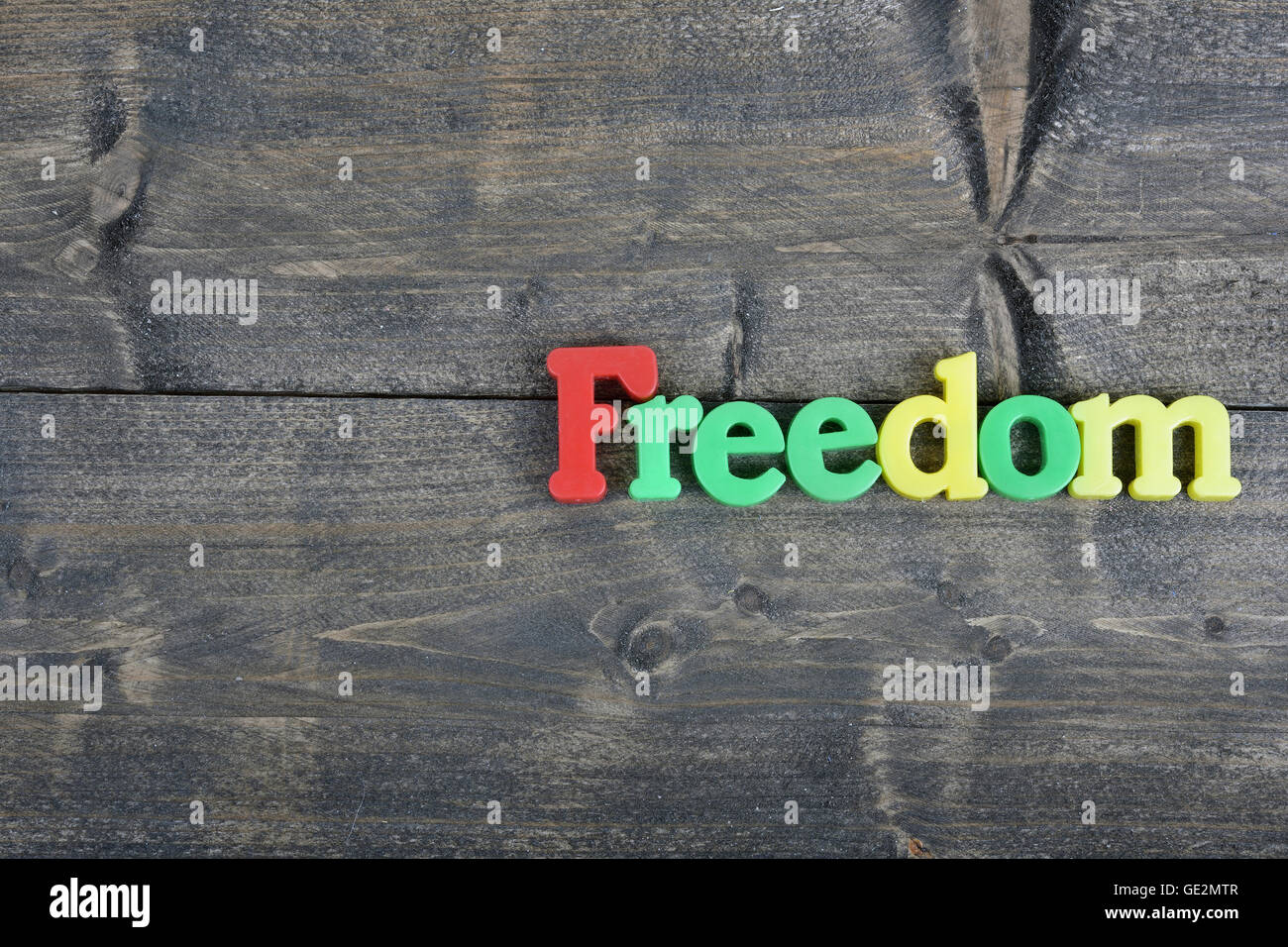 Freedom word on wooden table Stock Photo - Alamy
