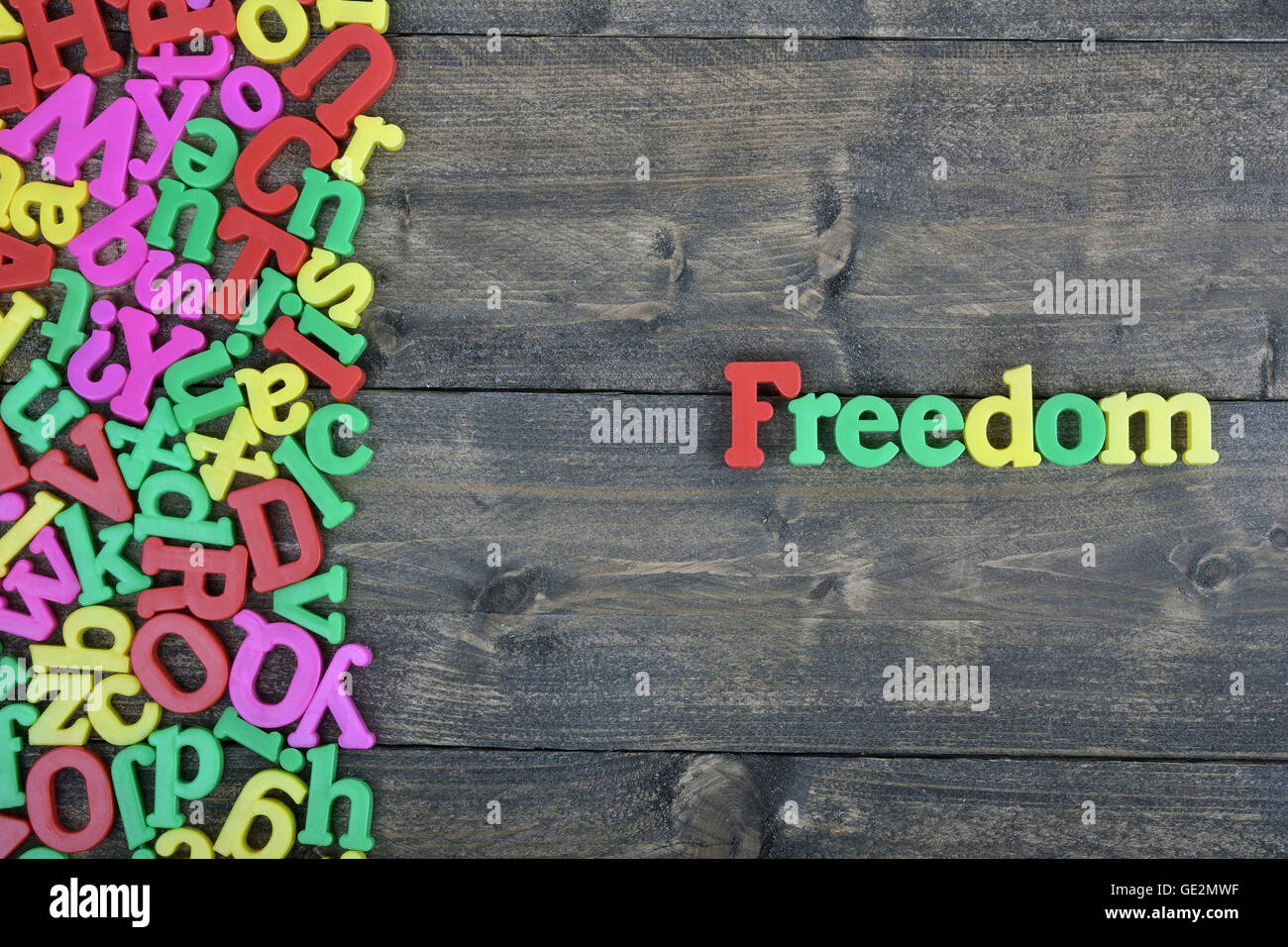 Freedom word on wooden table Stock Photo - Alamy