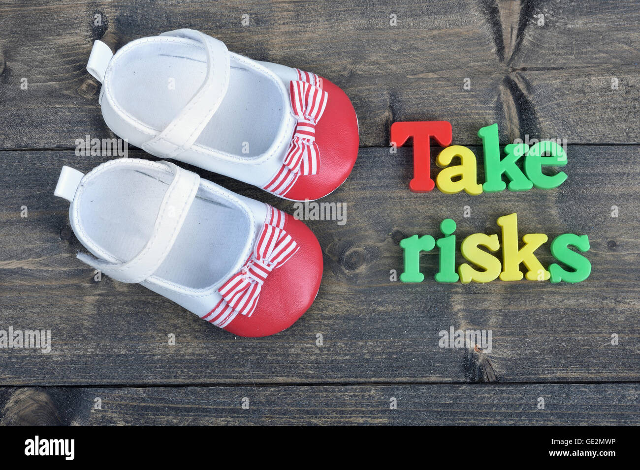 Take risks word on wooden table Stock Photo - Alamy