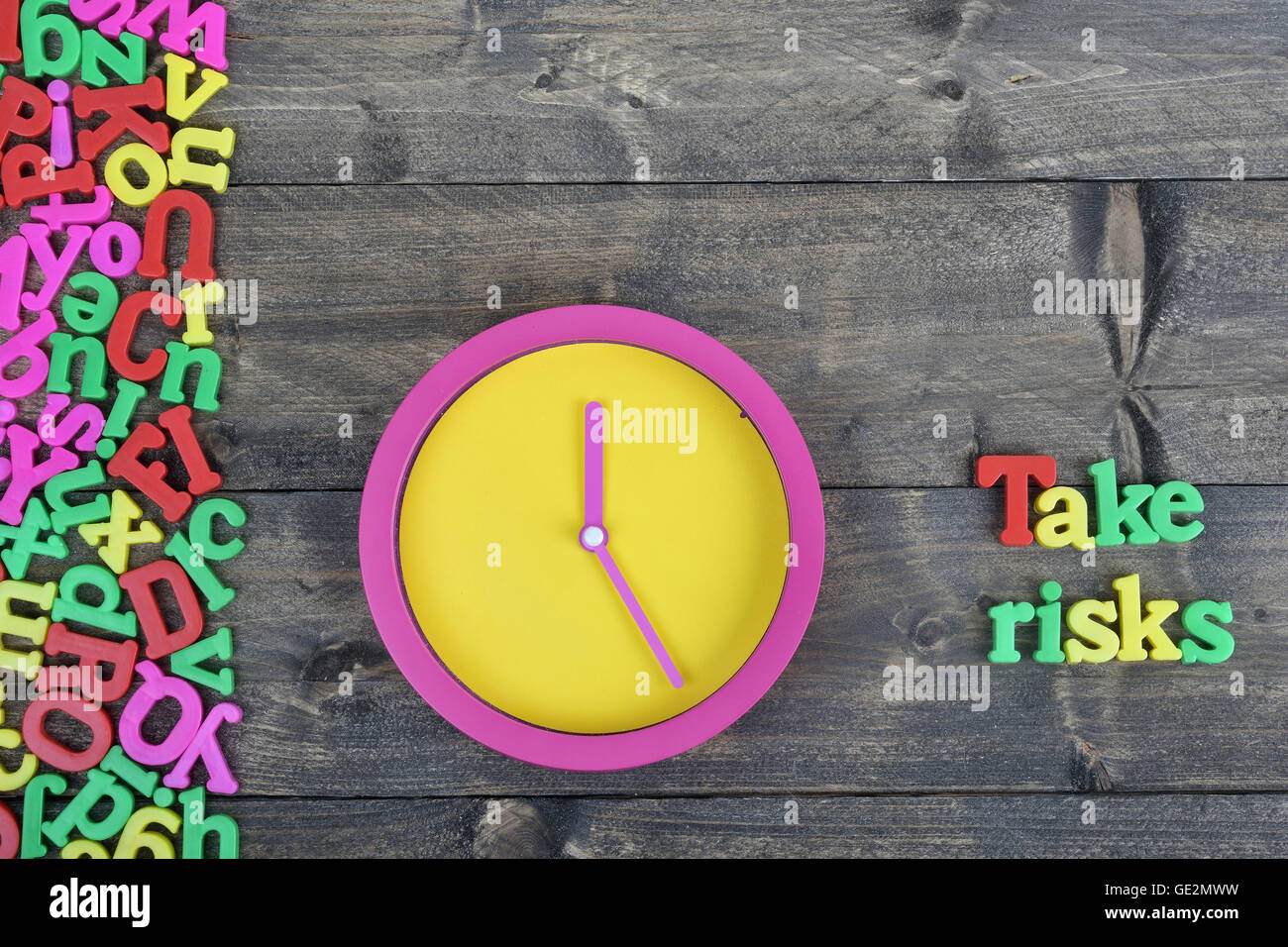 Take risks word on wooden table Stock Photo - Alamy