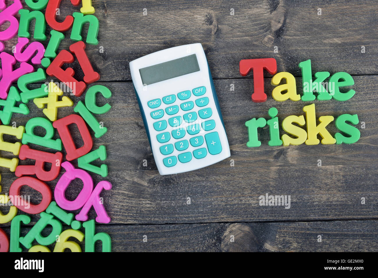 Take risks word on wooden table Stock Photo - Alamy
