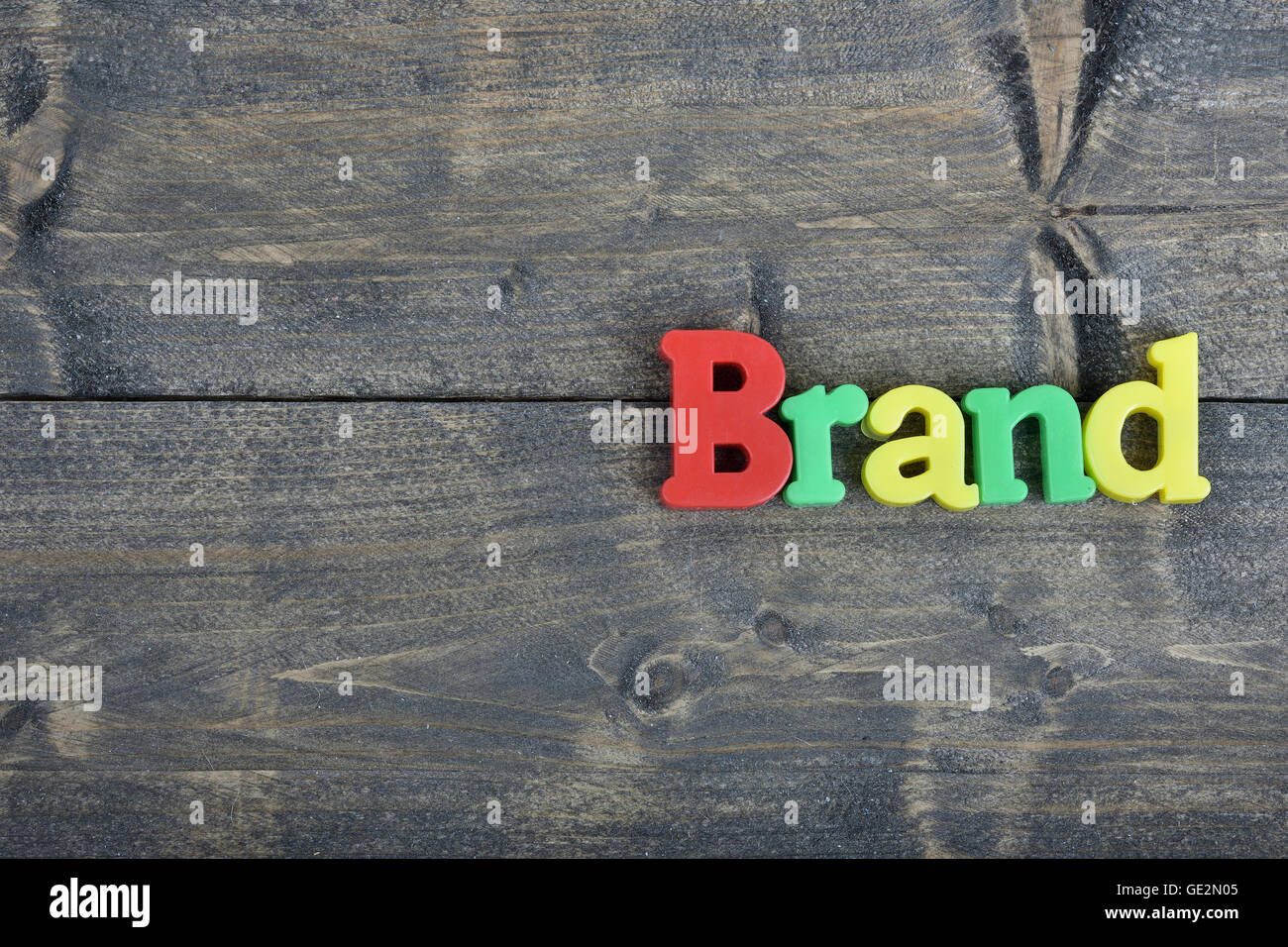 Brand word on wooden table Stock Photo - Alamy