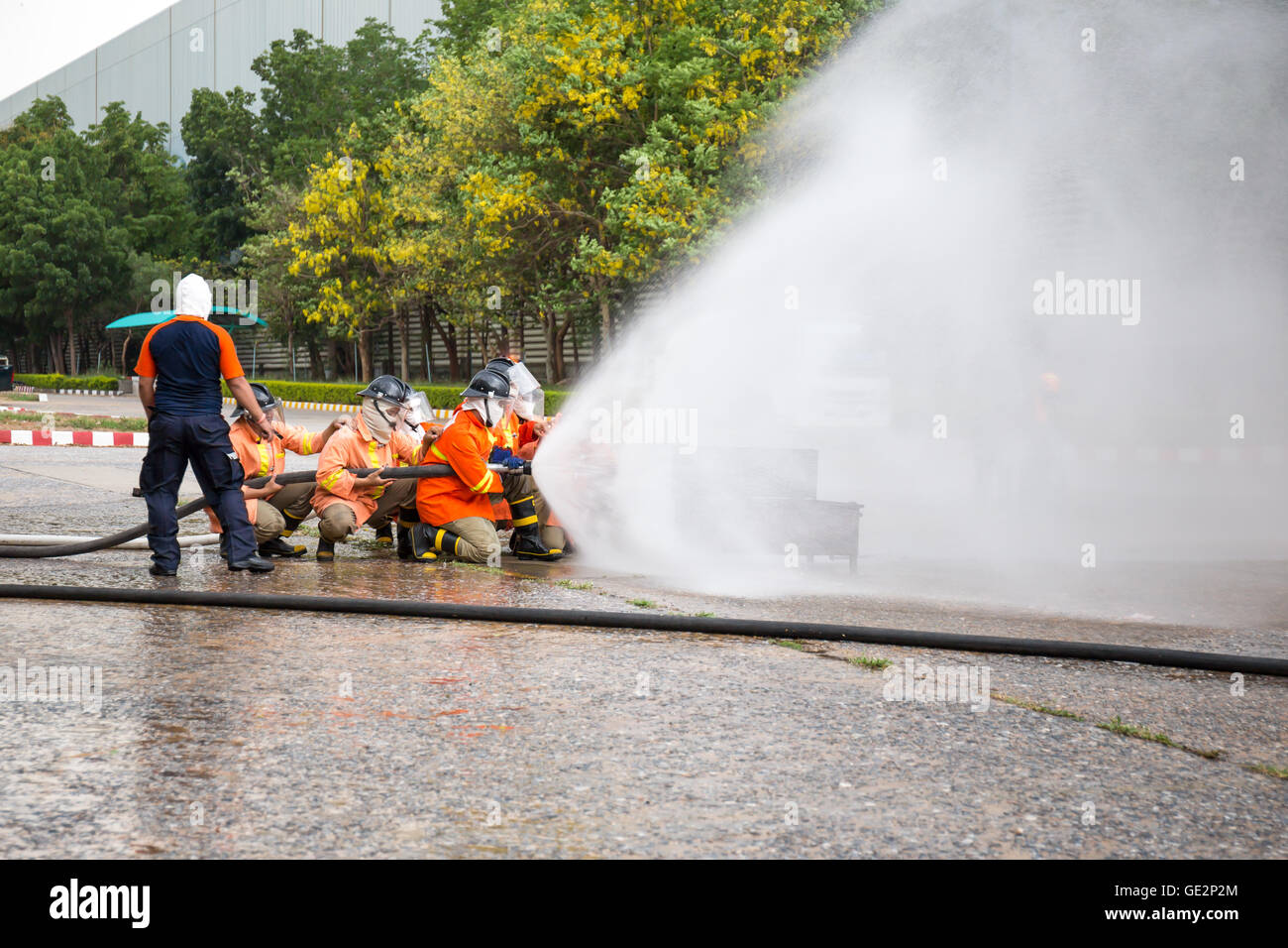Firefighters attack fire during a training exercise Stock Photo - Alamy